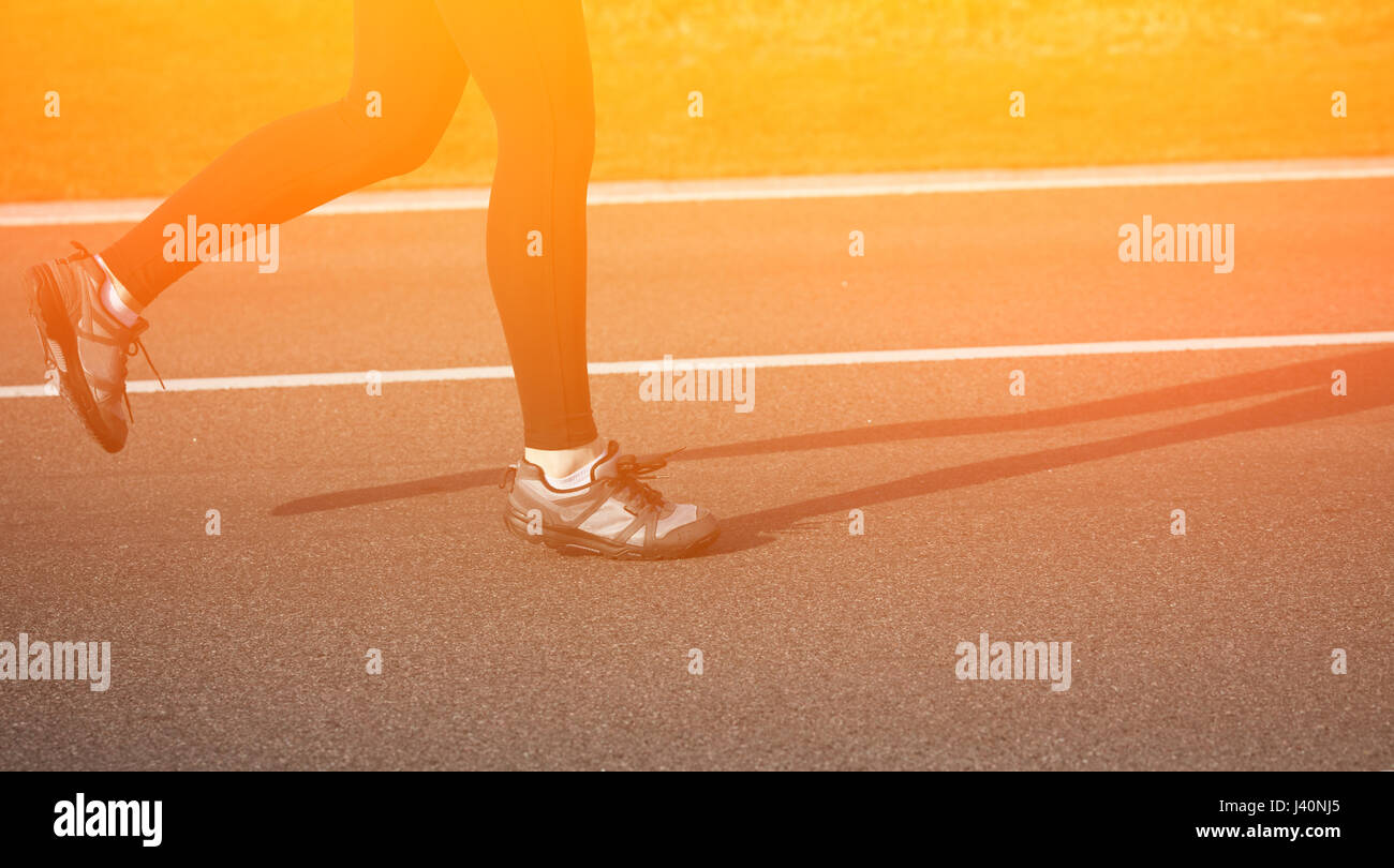 Jogging woman on track Stock Photo - Alamy