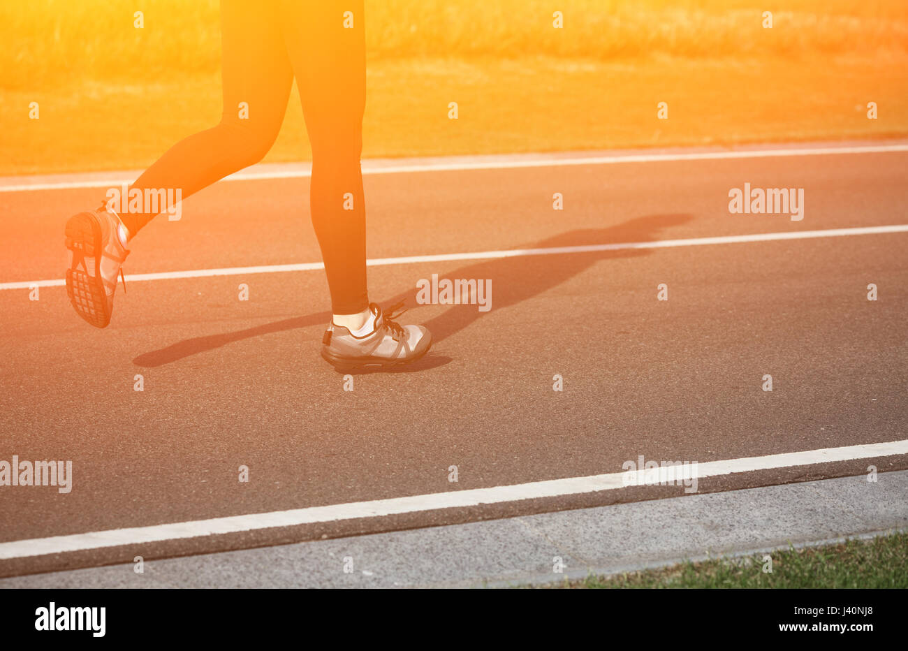Jogging woman on track Stock Photo - Alamy