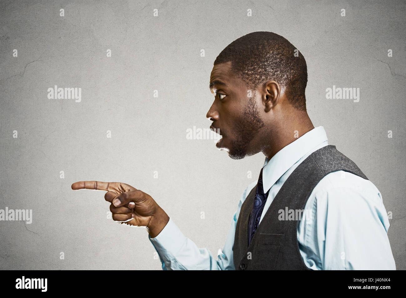 Closeup side view portrait handsome young Man Pointing with index ...