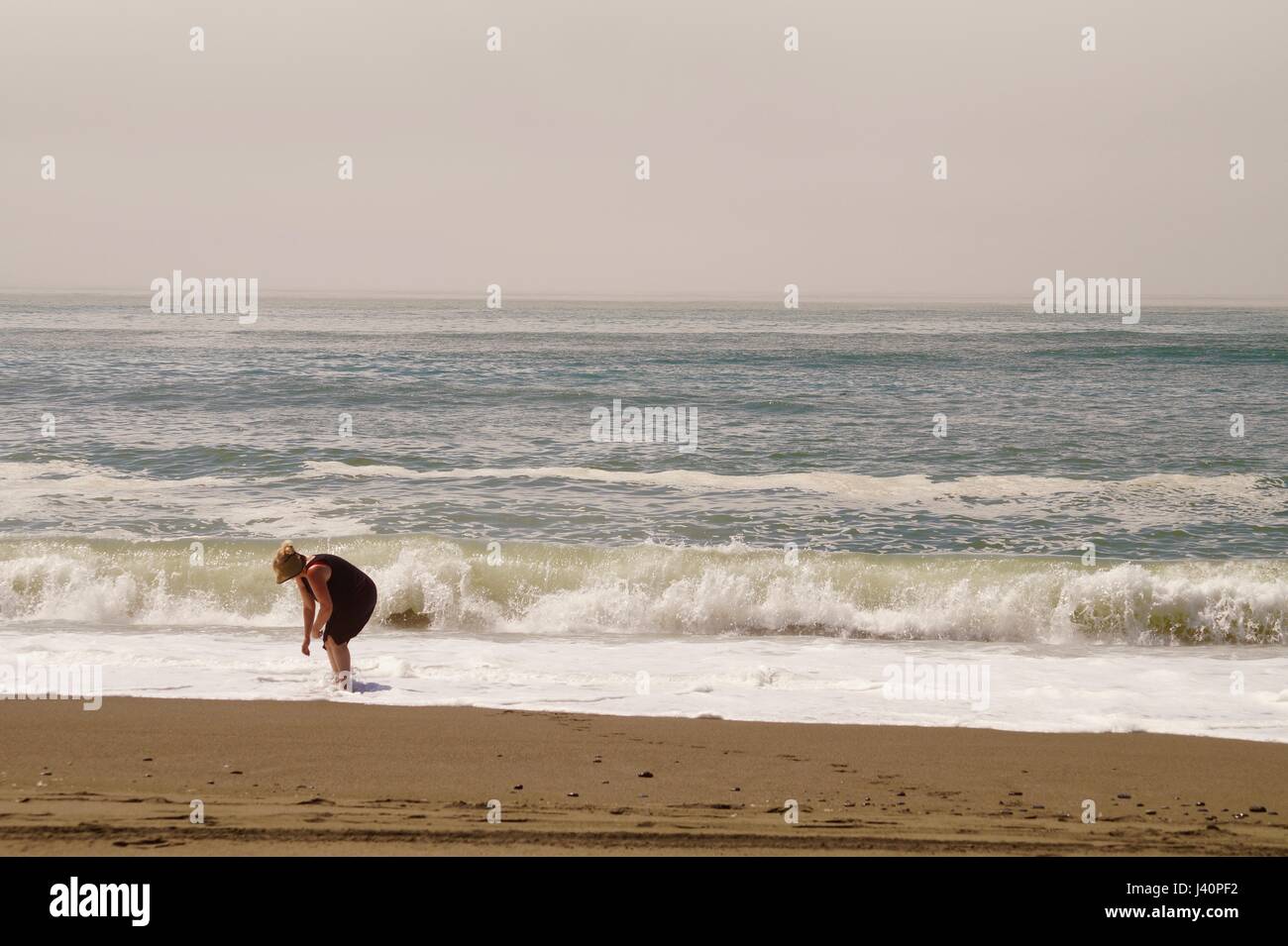 women strolling the beach collecting shells Stock Photo - Alamy