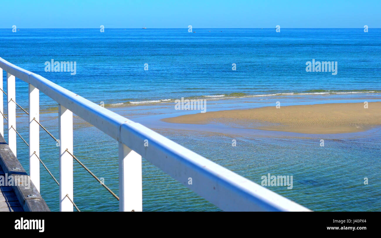 Overlooking sunny beach at low tide from jetty point of view Stock ...