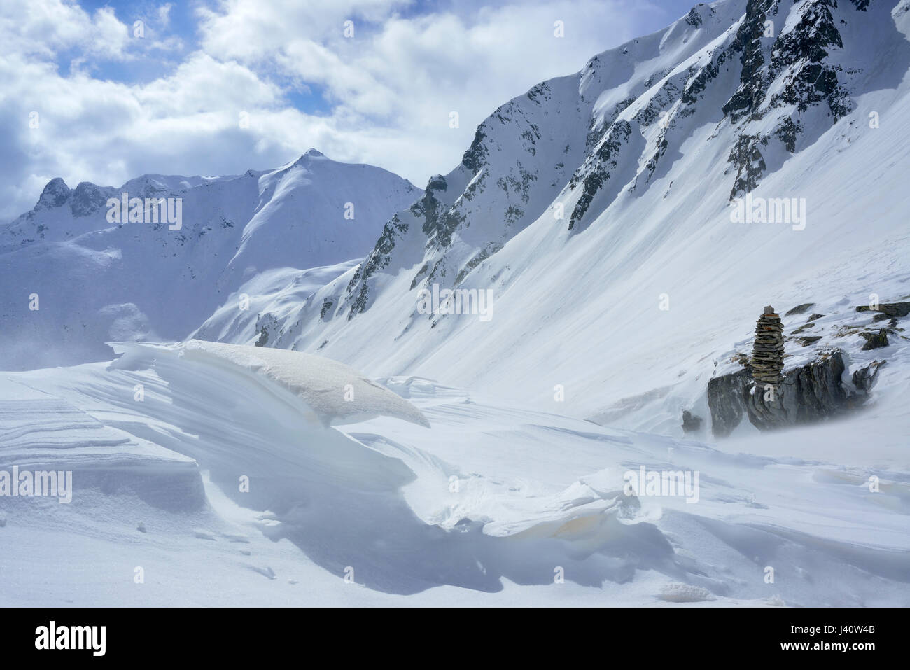 Snow erosion and cairn with Pfaffennock in background, Fuenfte ...