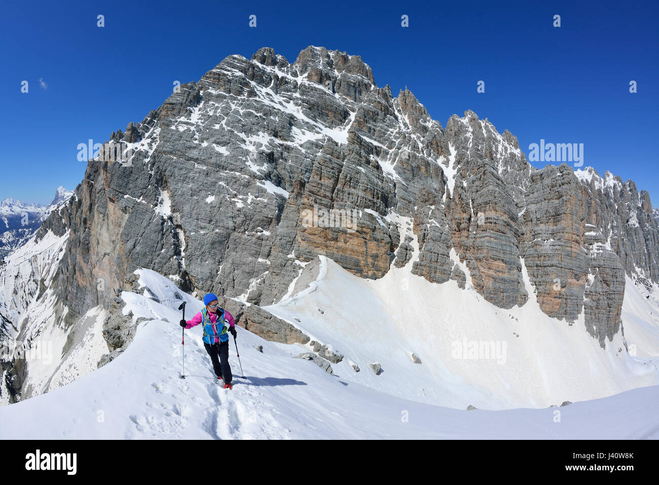 Female back-country skier ascending to Corno d Angolo, Cristallo Group ...