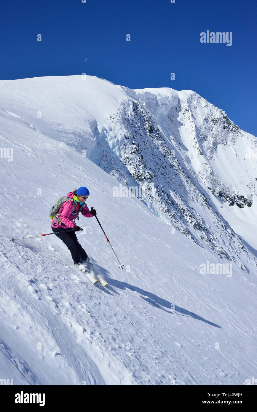 Female back-country skier downhill skiing from Grossvenediger ...