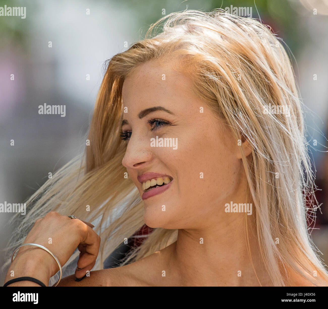 smiling attractive girl, styling hair Stock Photo - Alamy