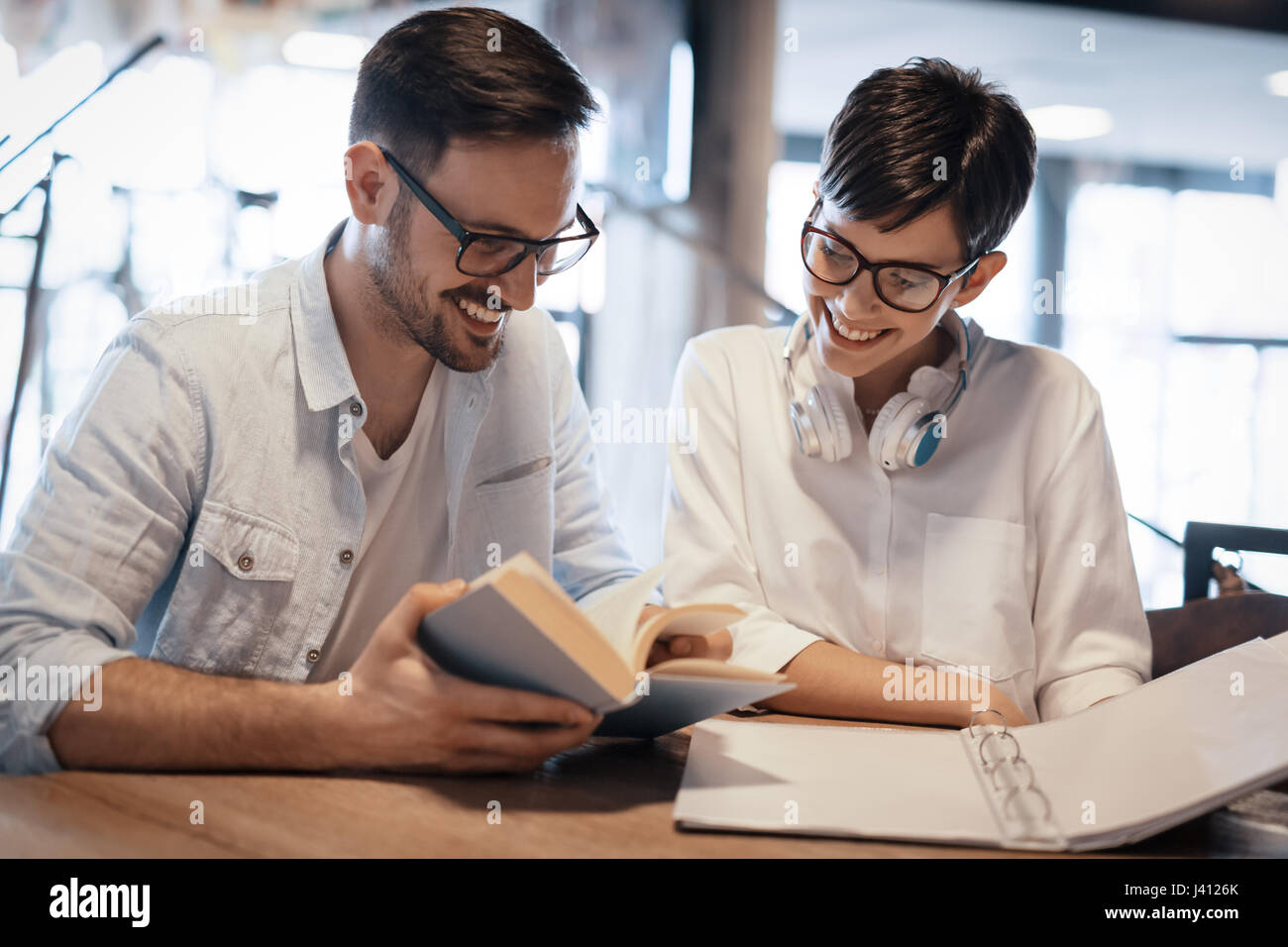 Happy students couple in school studying for exams together Stock Photo ...
