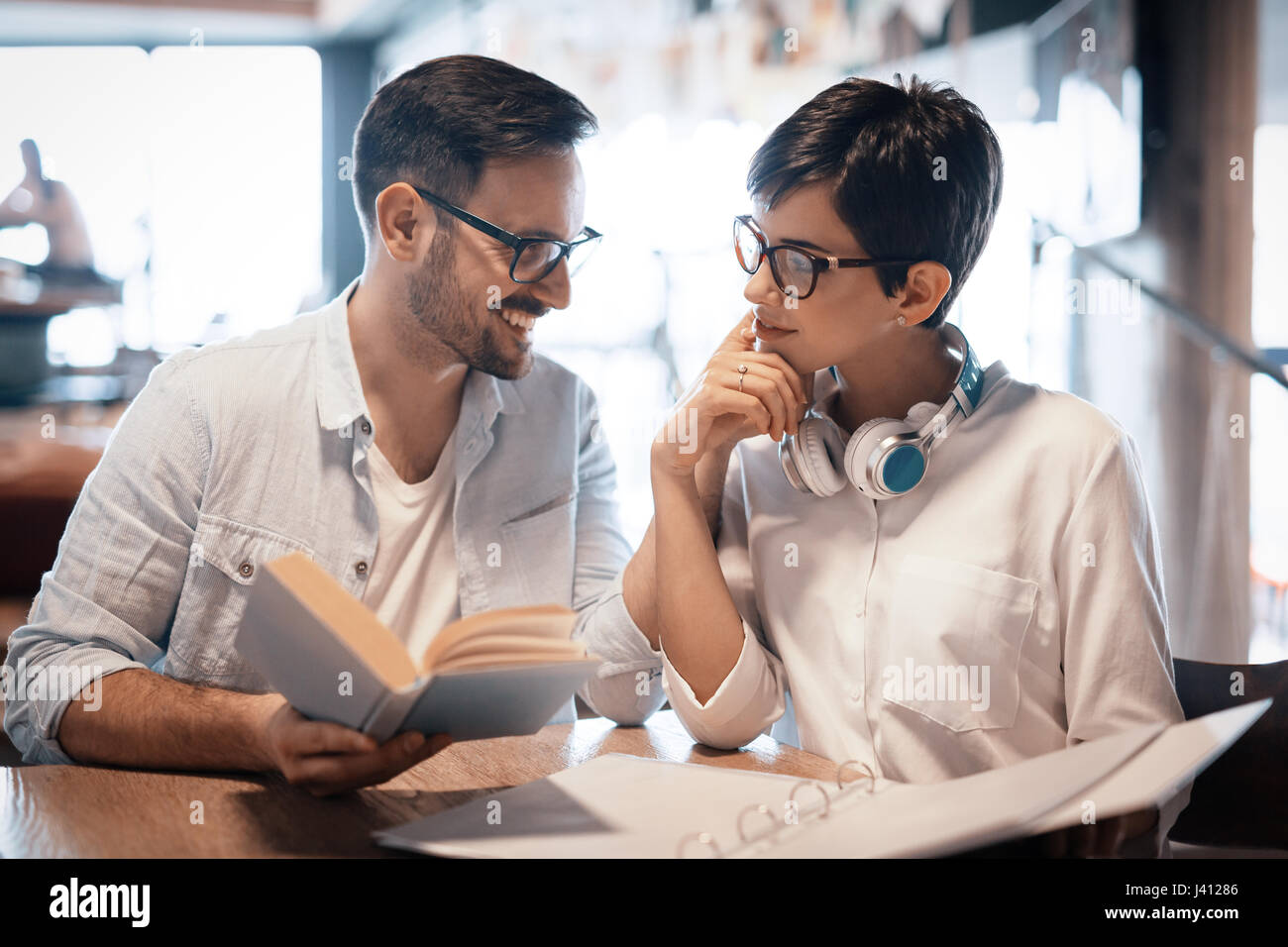 Happy students couple in school studying for exams together Stock Photo ...