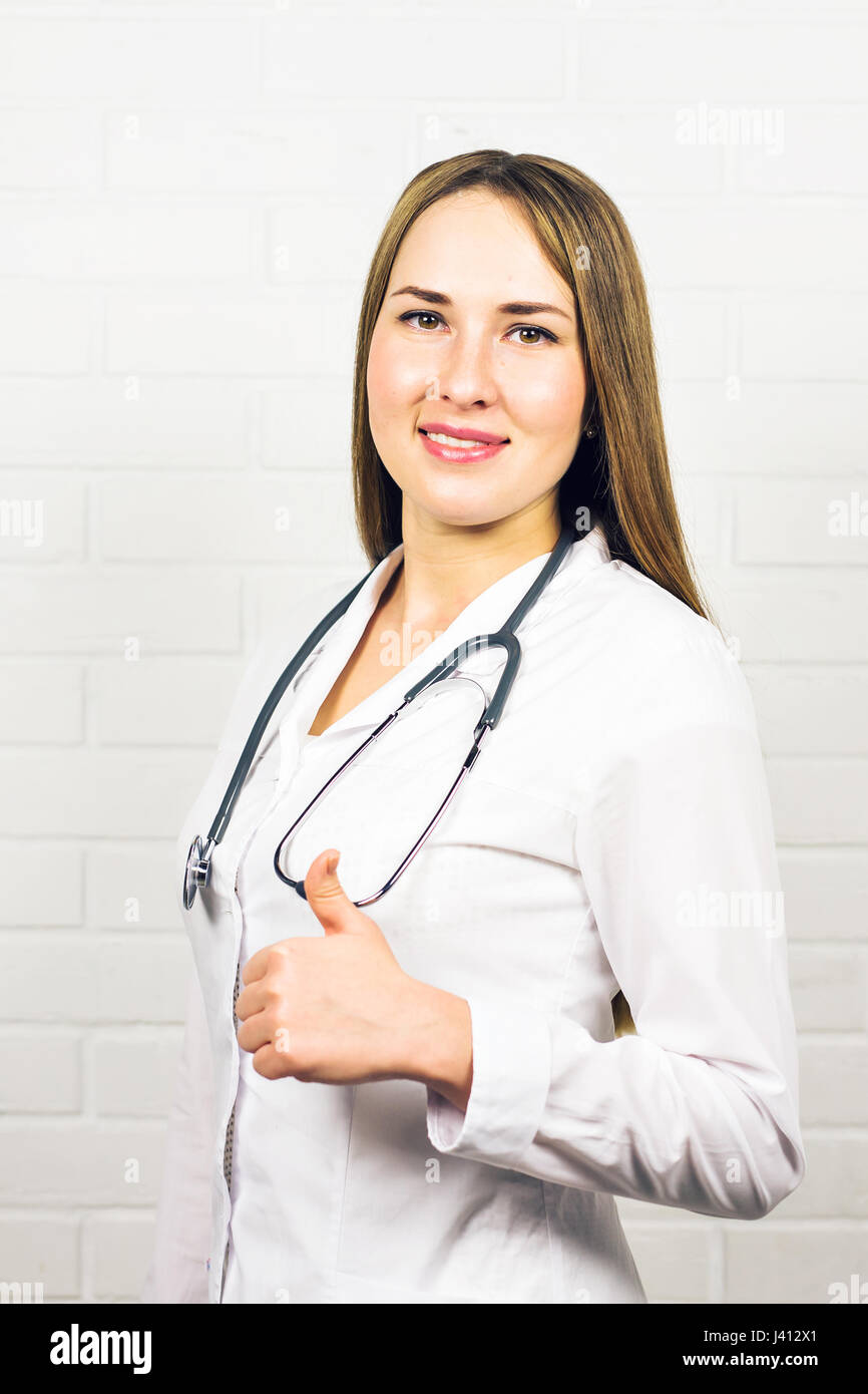 Portrait of cheerful doctor showing thumbs up gesture Stock Photo - Alamy
