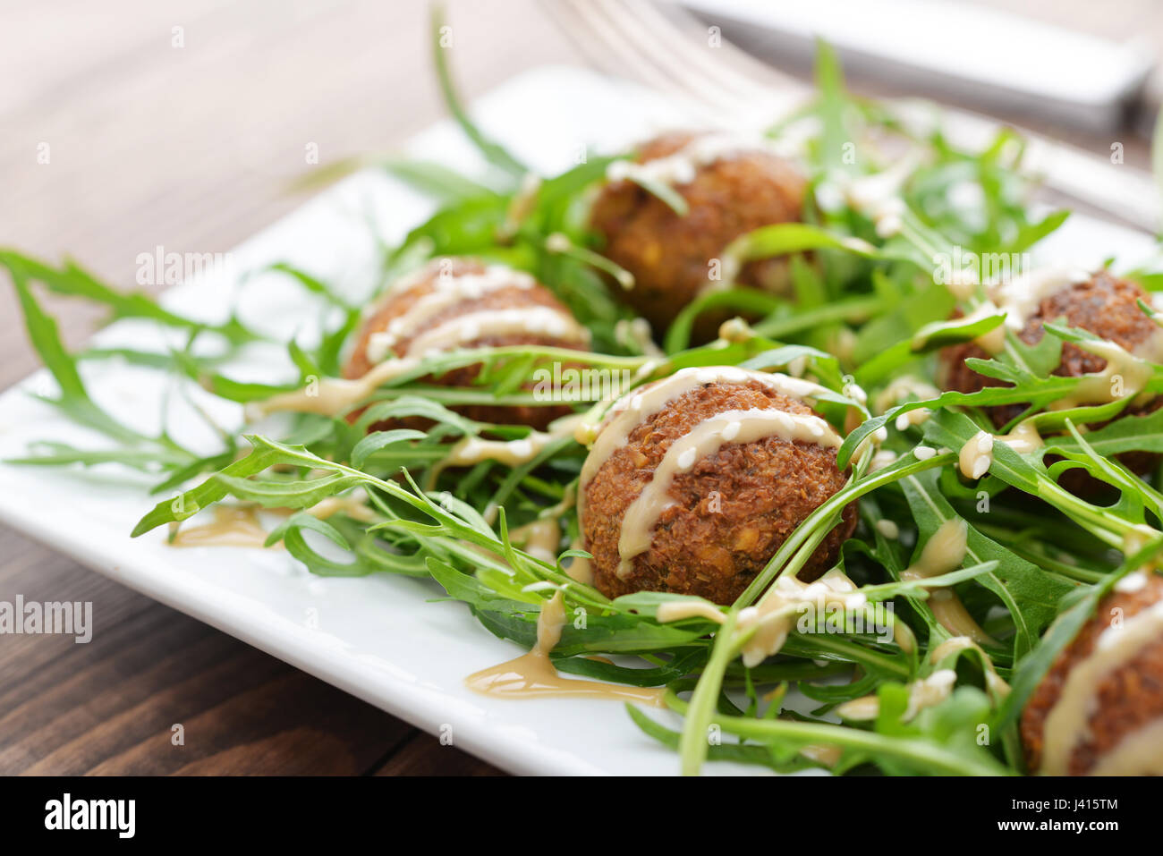 Fresh vegetarian falafel with arugula on plate closeup Stock Photo - Alamy
