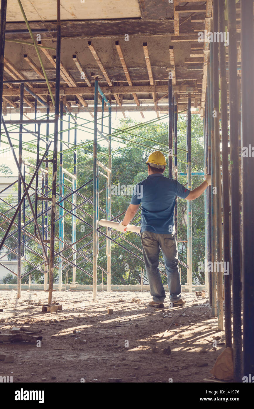 Construction concepts, Engineer and Architect working at Construction Site with blueprint ...