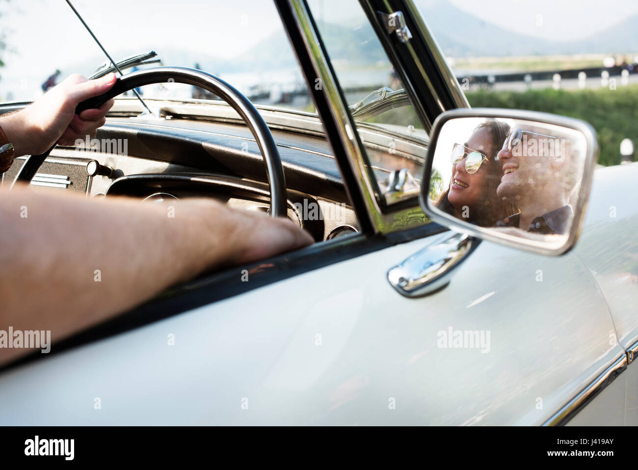 Couple Driving a Car Traveling on Road Trip Together Stock Photo - Alamy