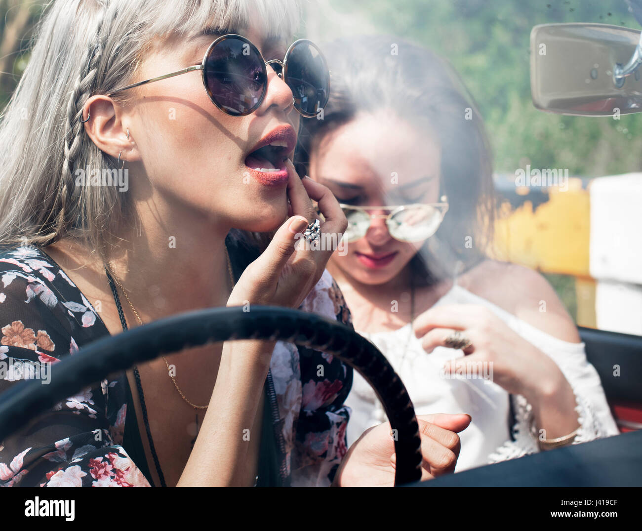 Woman Sitting in a Car Putting Lipstick on Lips with Rear Mirror Stock ...