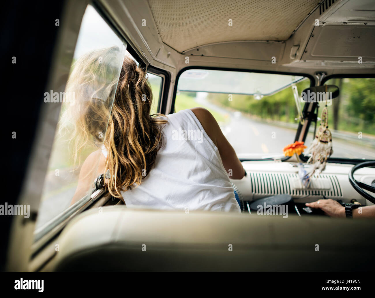 Woman Sitting in a Car Put Head Out of Window Wind Blowing Her Hair ...