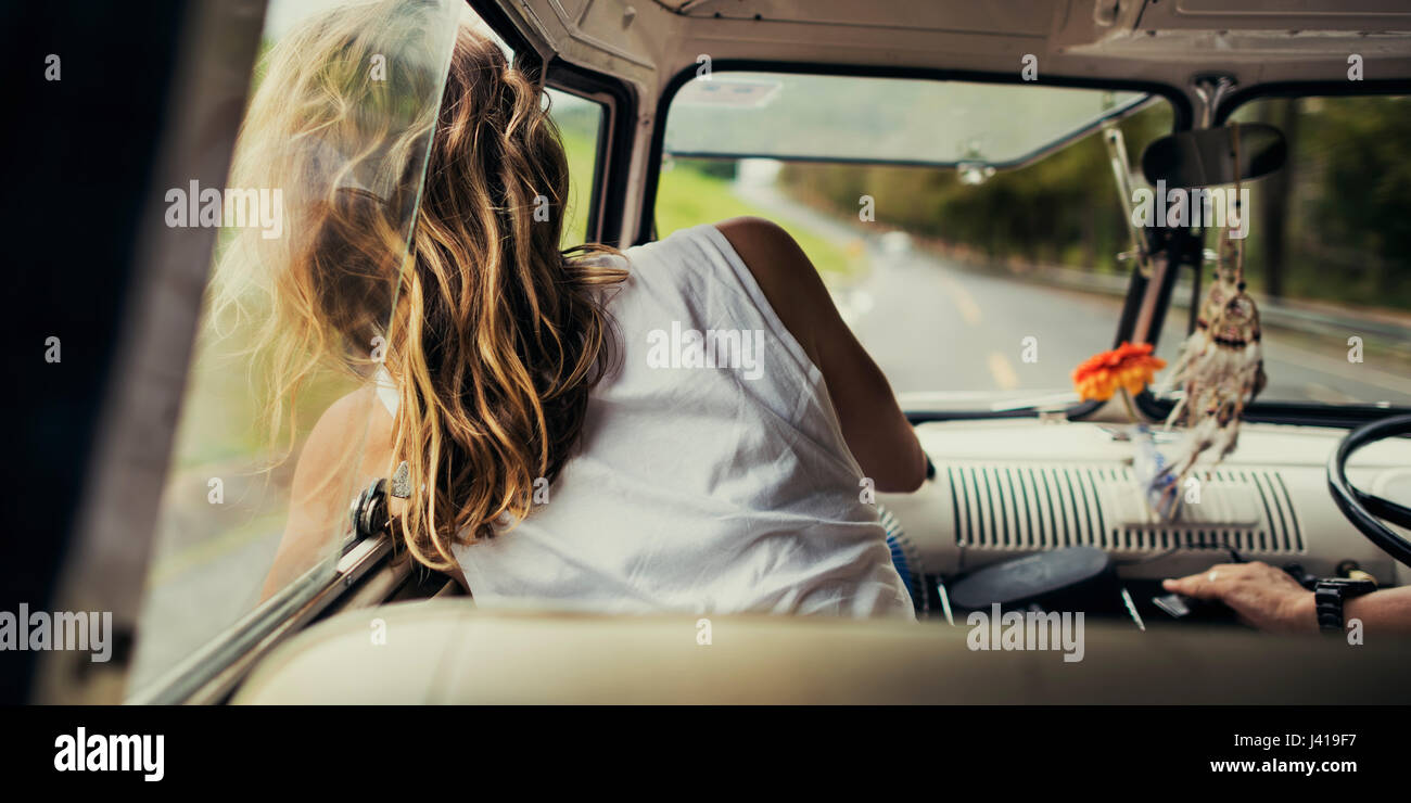 Woman Sitting in a Car Put Head Out of Window Wind Blowing Her Hair ...