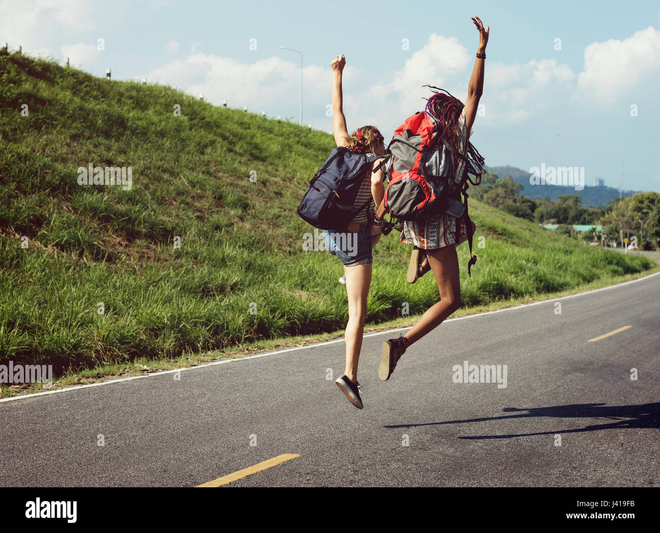Diverse Backpacker Women Jumping The Street Stock Photo - Alamy