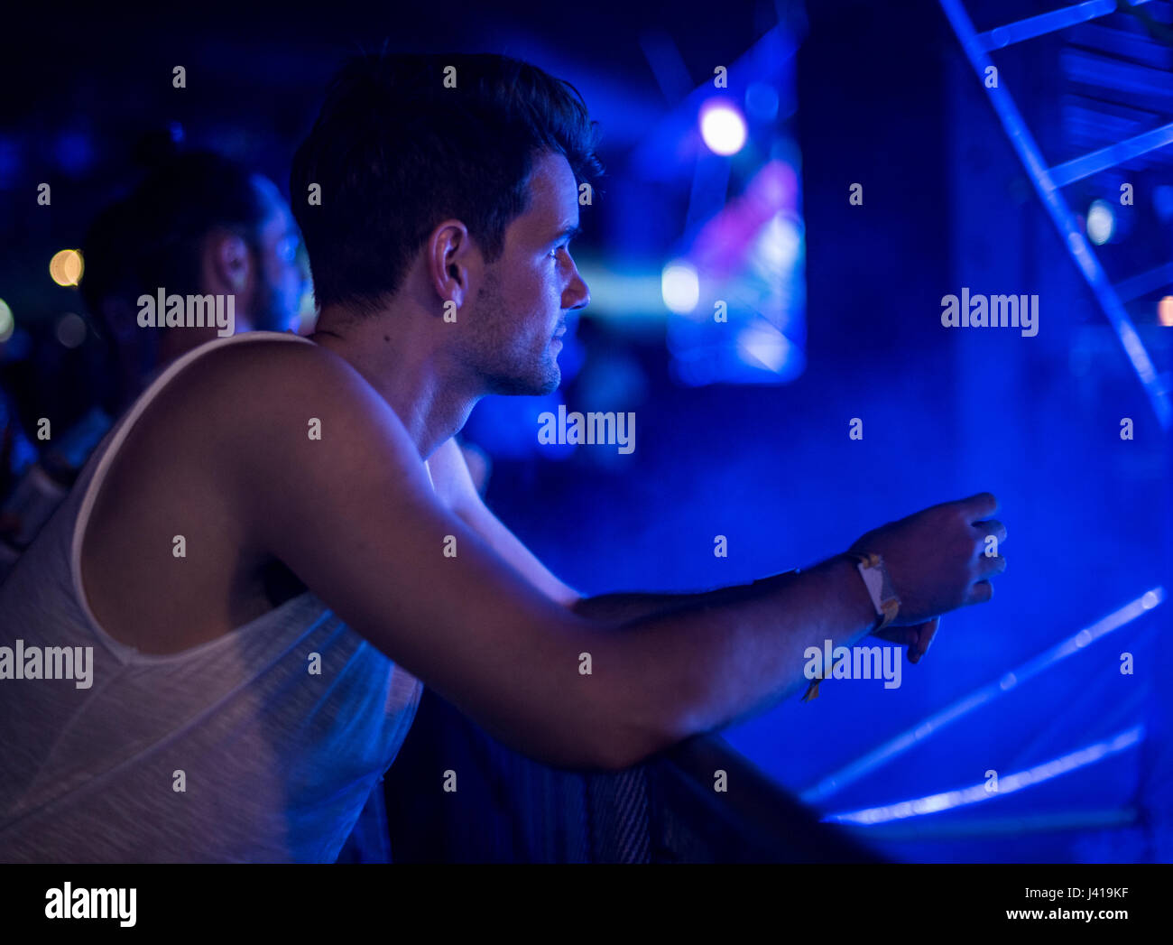 Man Sitting Alone Watching Live Concert Stock Photo - Alamy