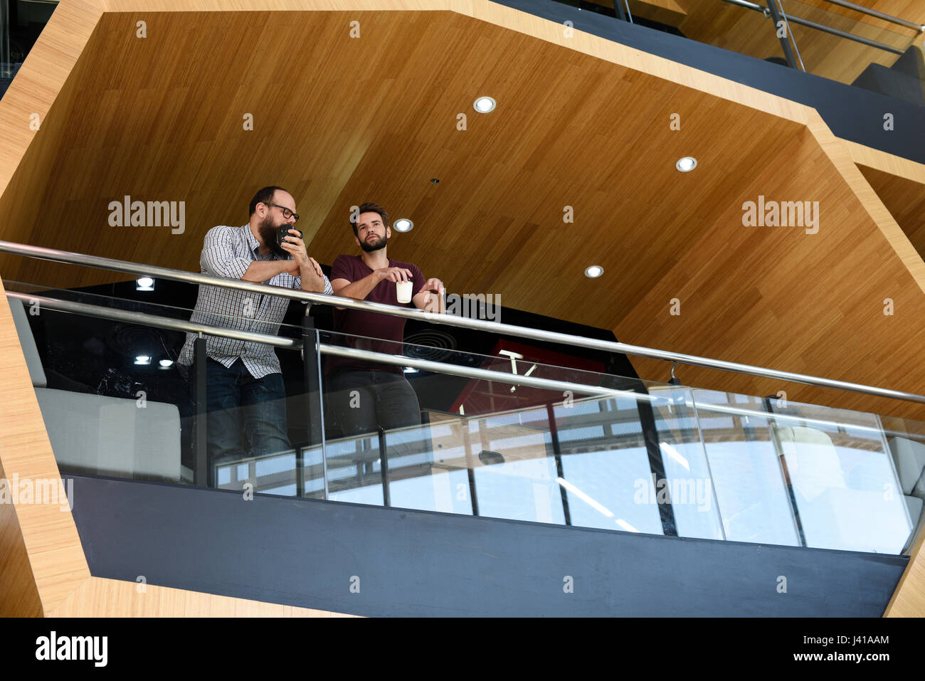 People Talking Together During Office Break Time Stock Photo - Alamy