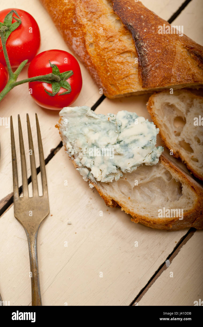 fresh blue cheese spread ove french baguette with cherry tomatoes on ...