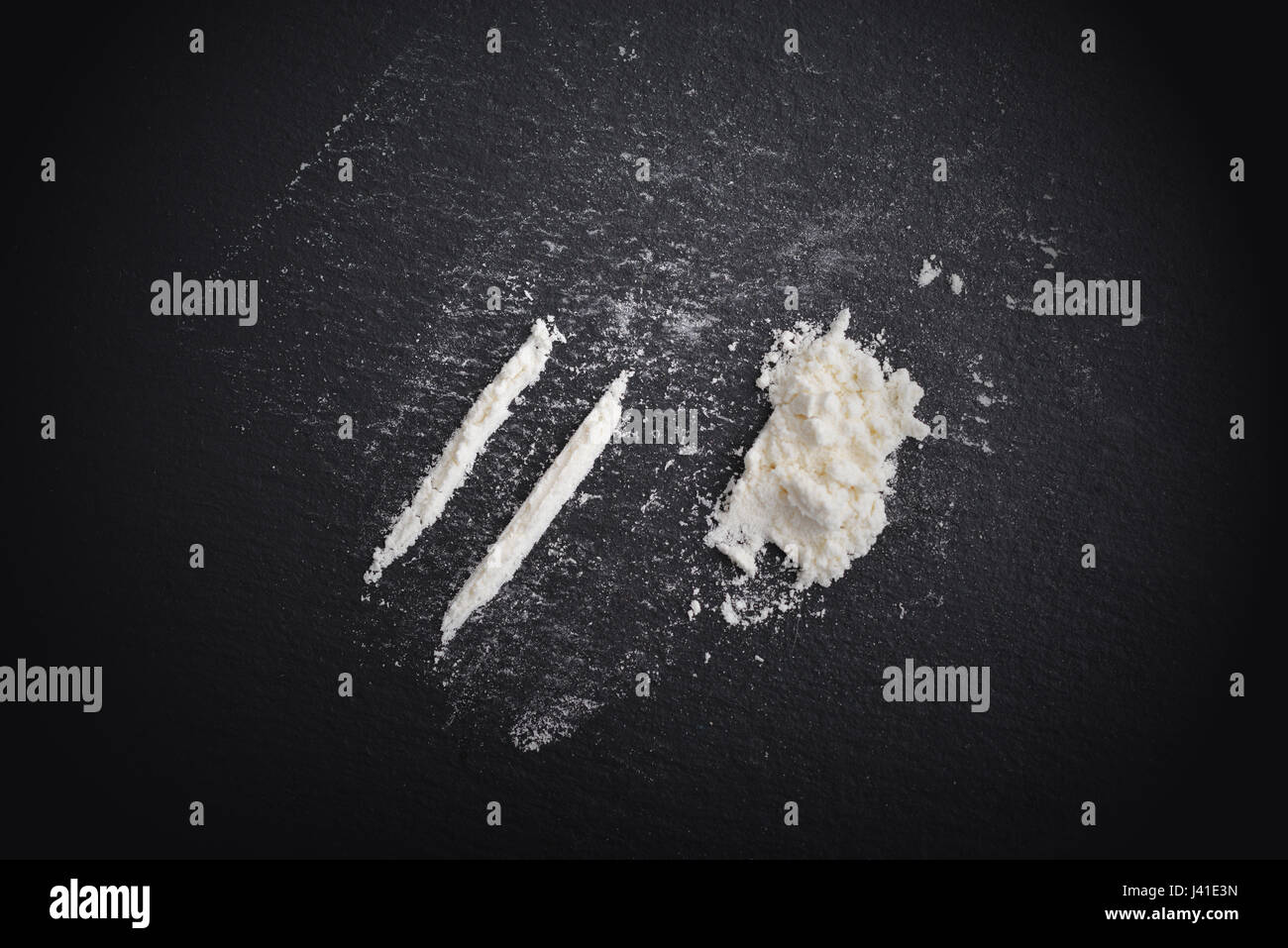 Cocaine drug addiction. Lines of cocaine on black background top view ...