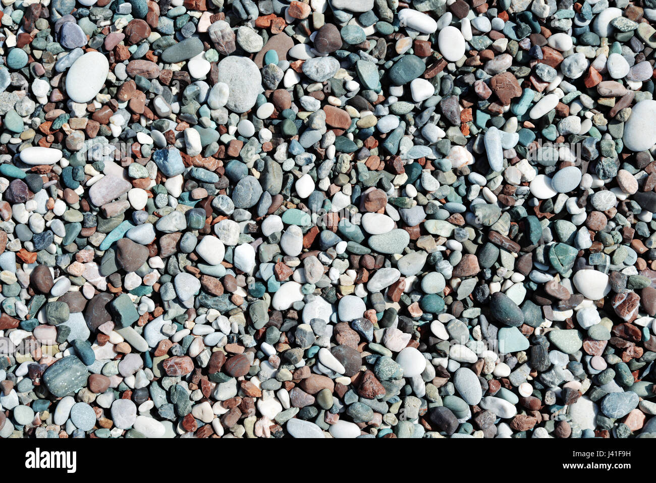 Colorful sea stones on beach, top view Stock Photo - Alamy