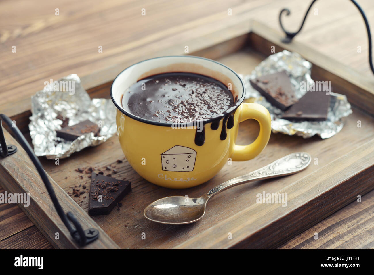 Hot chocolate in mug with chocolate bar on vintage tray over wooden ...