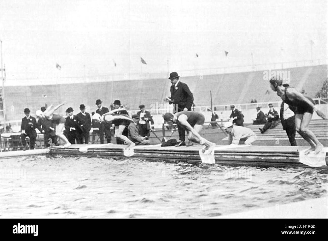 This historical photograph captures a swimming event in London in 1908 ...