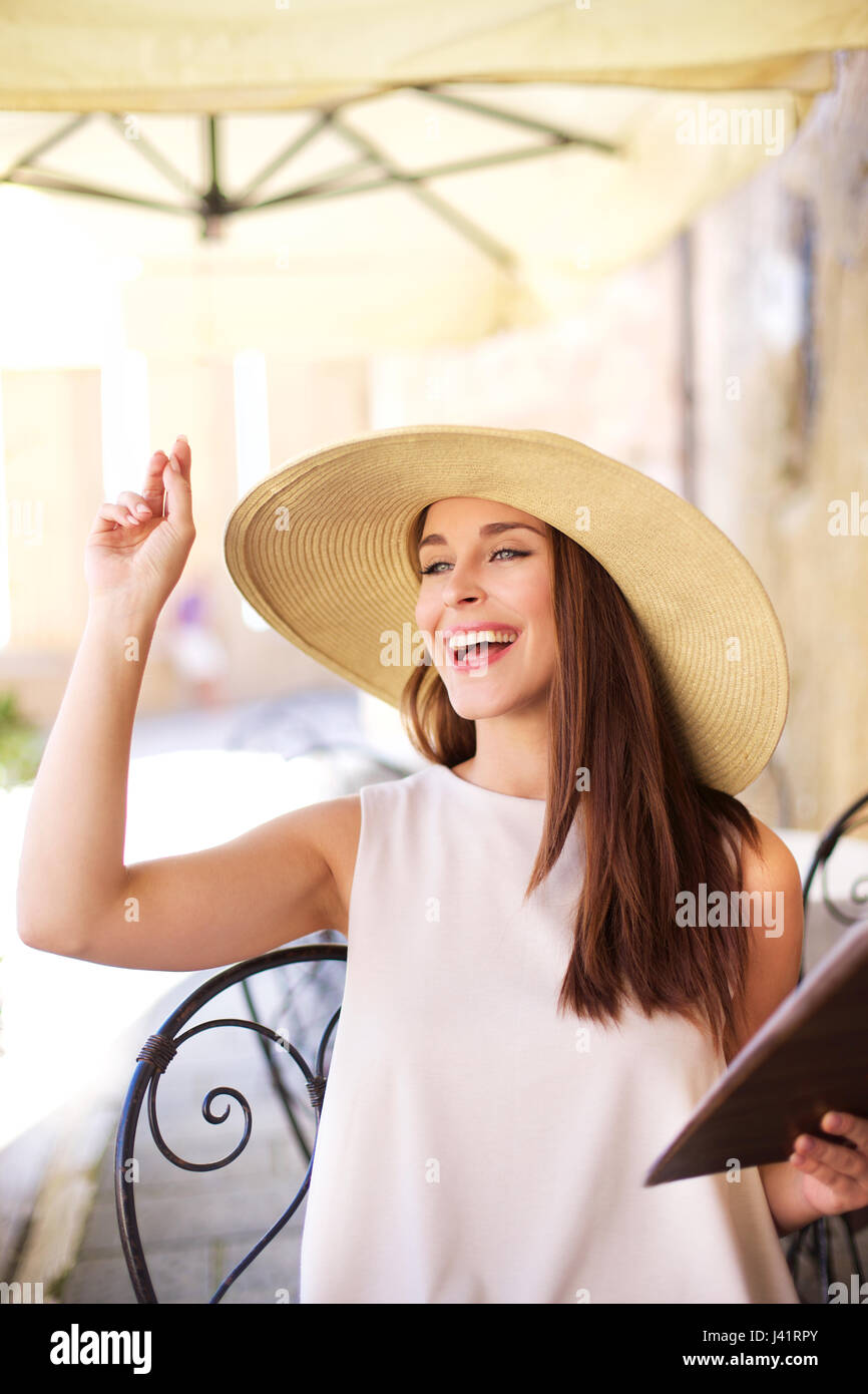Young women calling the waitress Stock Photo - Alamy