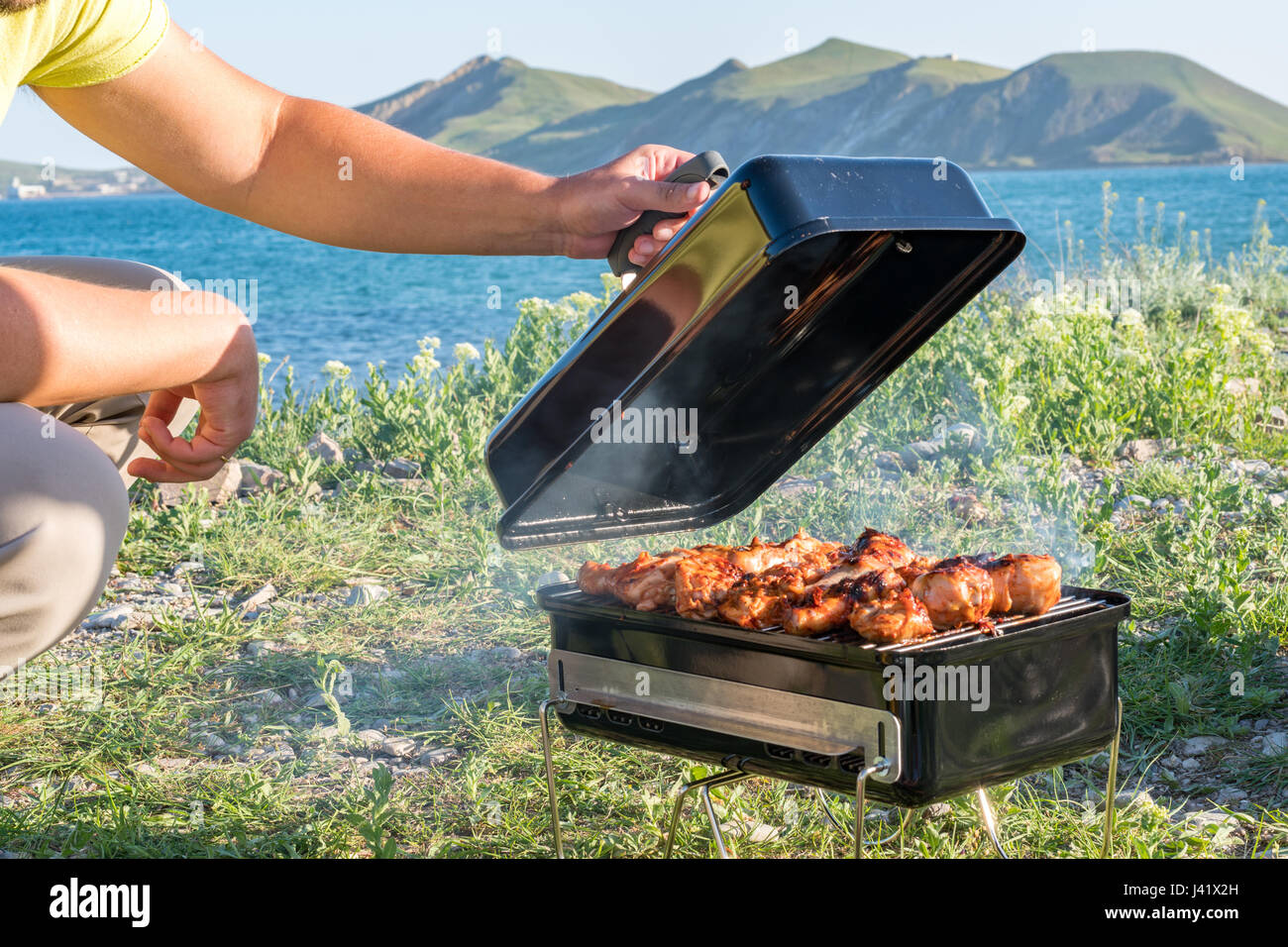 Cooking on the barbecue grill. Outdoor weekend time. Near the sea beach ...