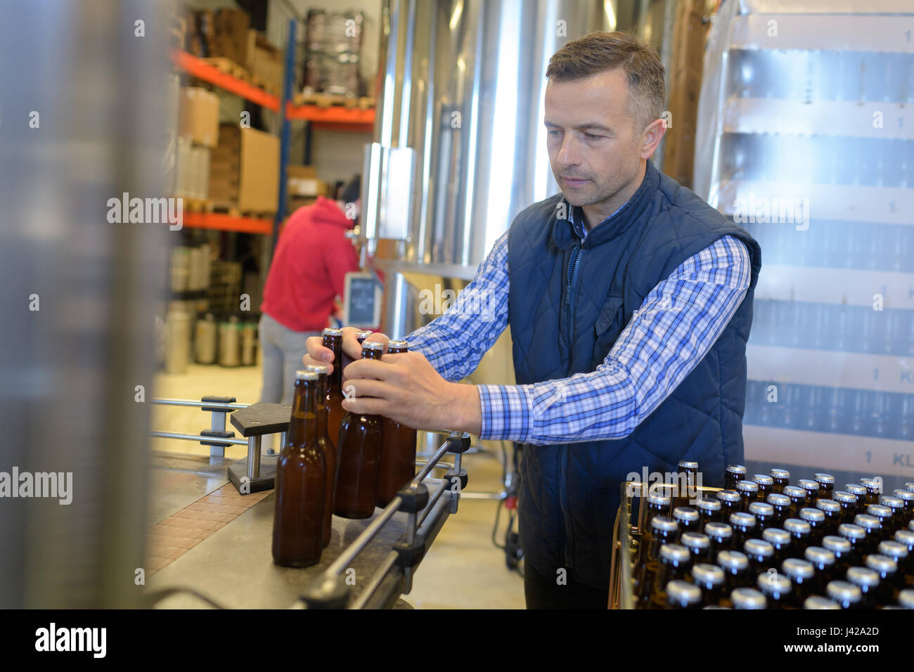 Factory operative packing bottles from end of production line Stock ...
