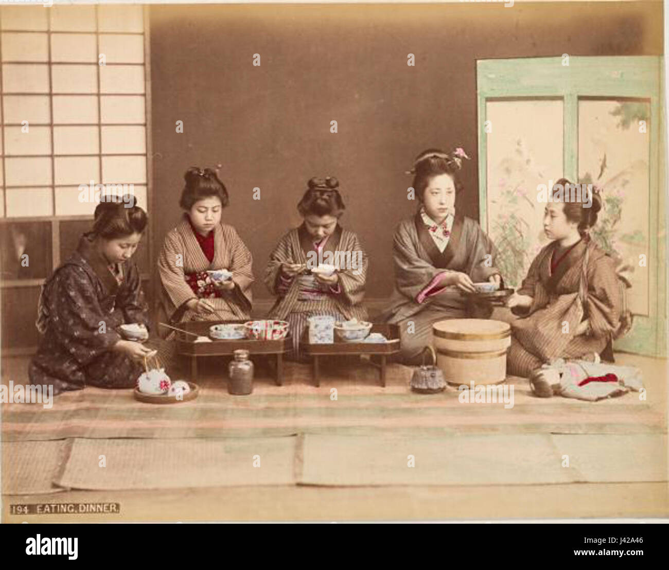 This photograph by Kusakabe Kimbei, titled 'Eating. Dinner' (194 ...