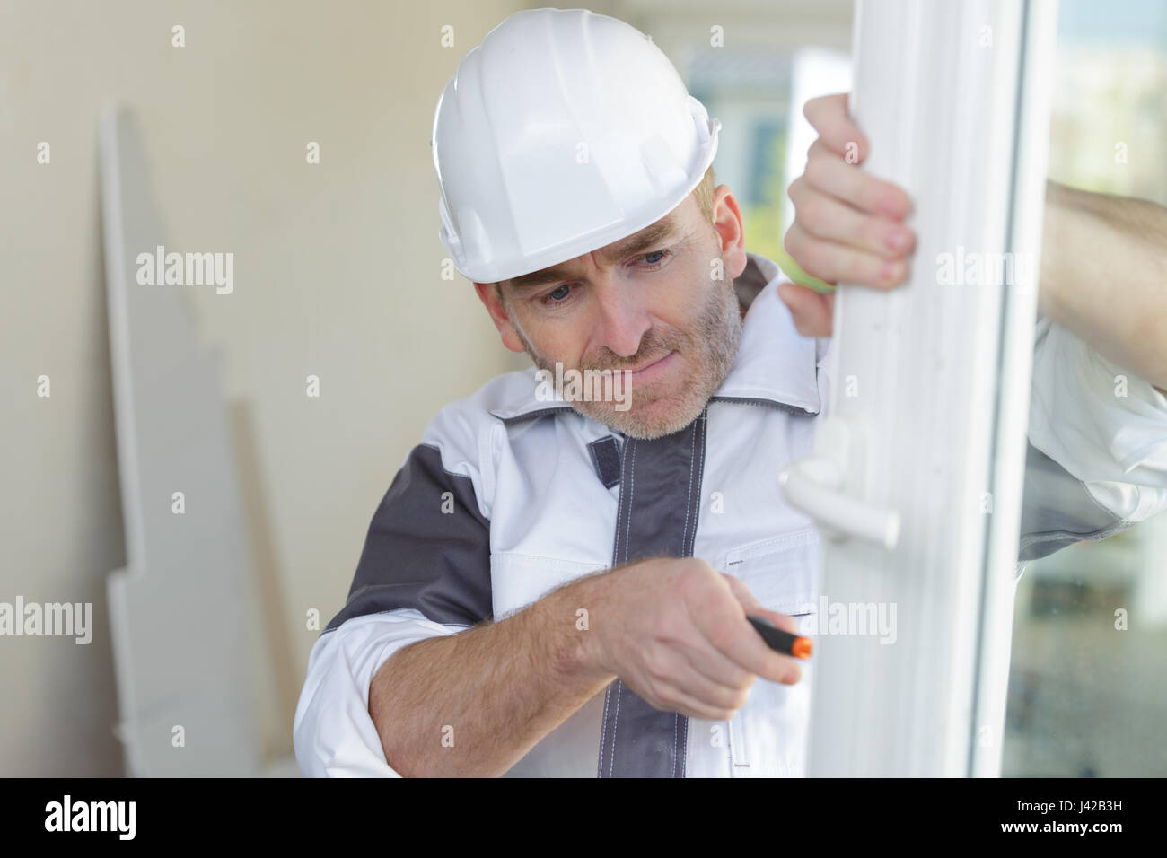 Man fitting new pvc windows Stock Photo - Alamy