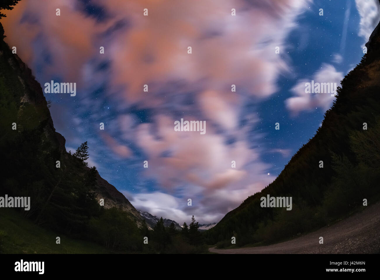 The starry sky with blurred motion colorful clouds and bright moonlight ...