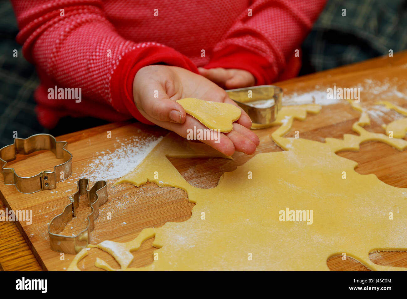little cute girl puts on baking cookies child making cake Stock Photo ...