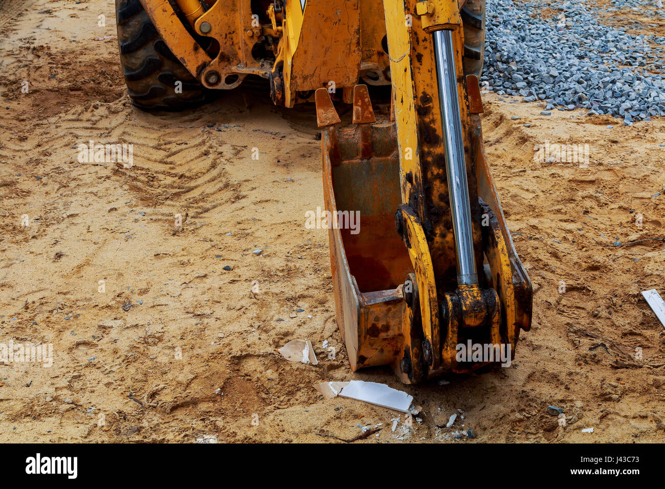 Yellow excavator loader at construction site with raised bucket Stock ...