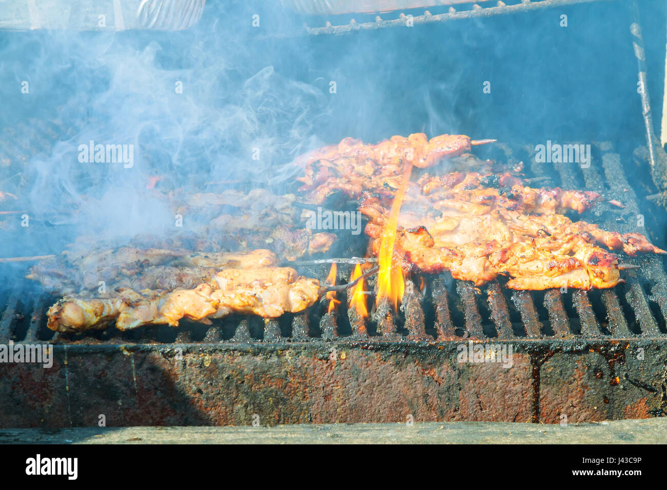fresh kebab prepares on the fire outdoors barbecue fire smoke Stock ...