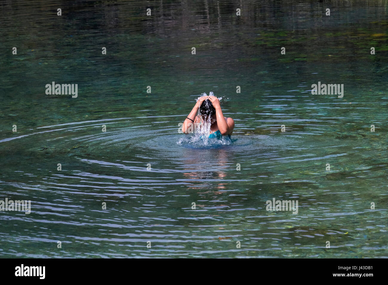 Local woman bathing in Rio La Pasion river in Peten department northern ...