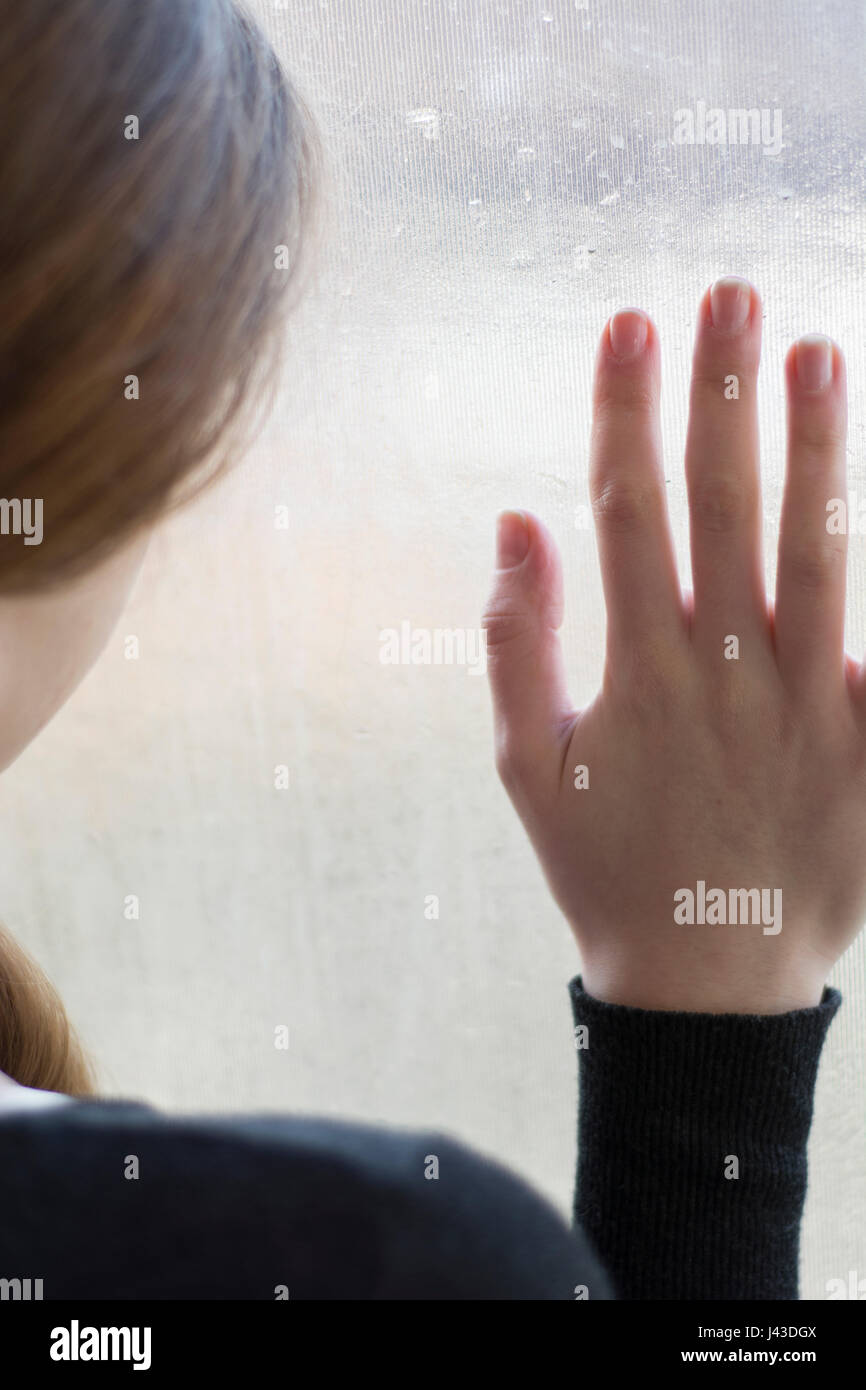 Sad young woman hand touching the window Stock Photo - Alamy