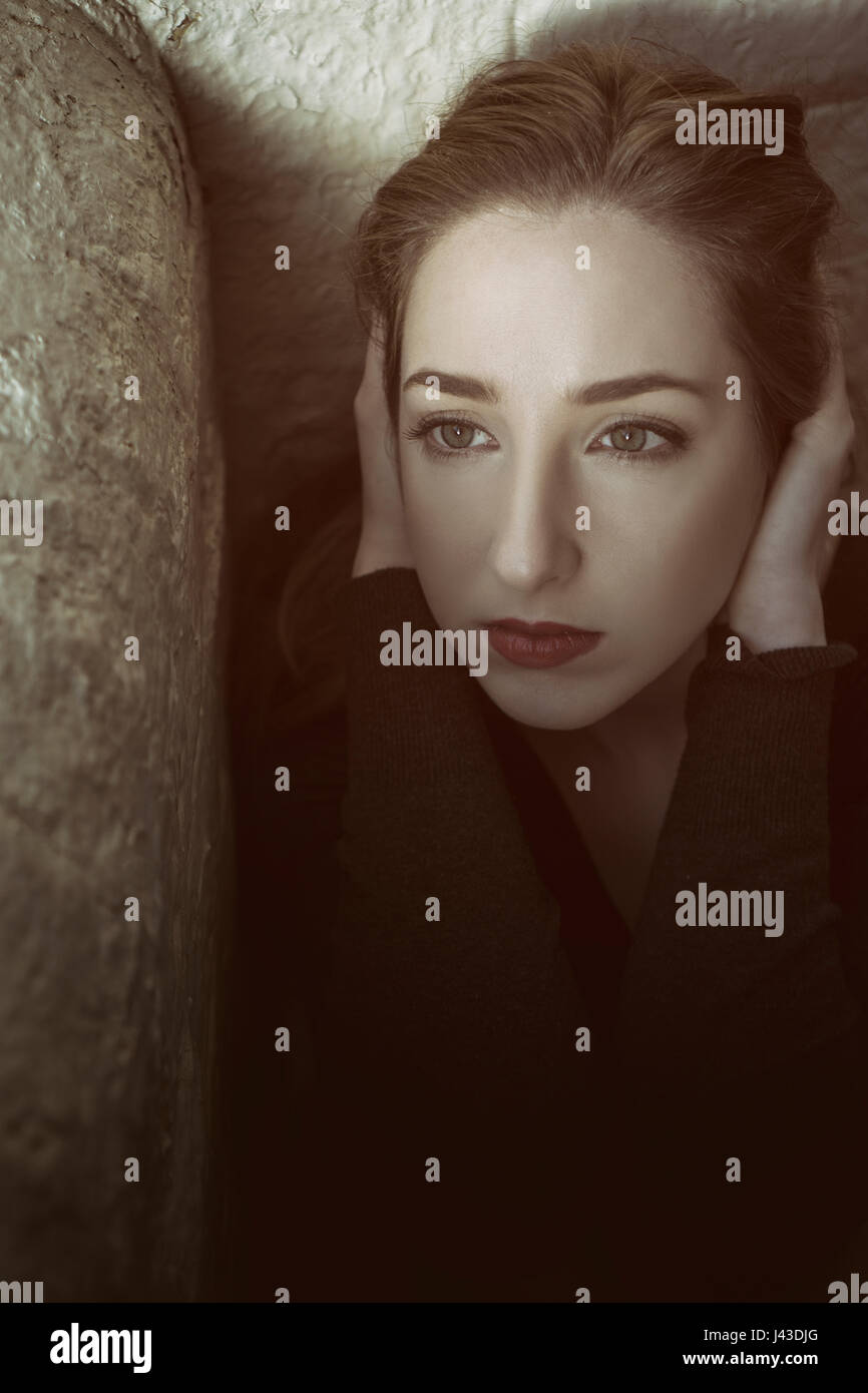 Woman sitting down scared hi-res stock photography and images - Alamy