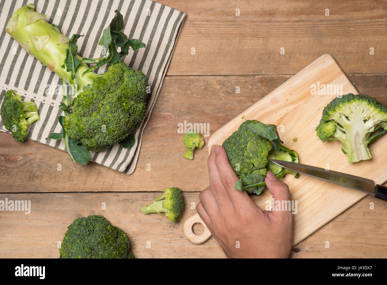Top view of Chef hand cutting broccoli for cooking Stock Photo - Alamy
