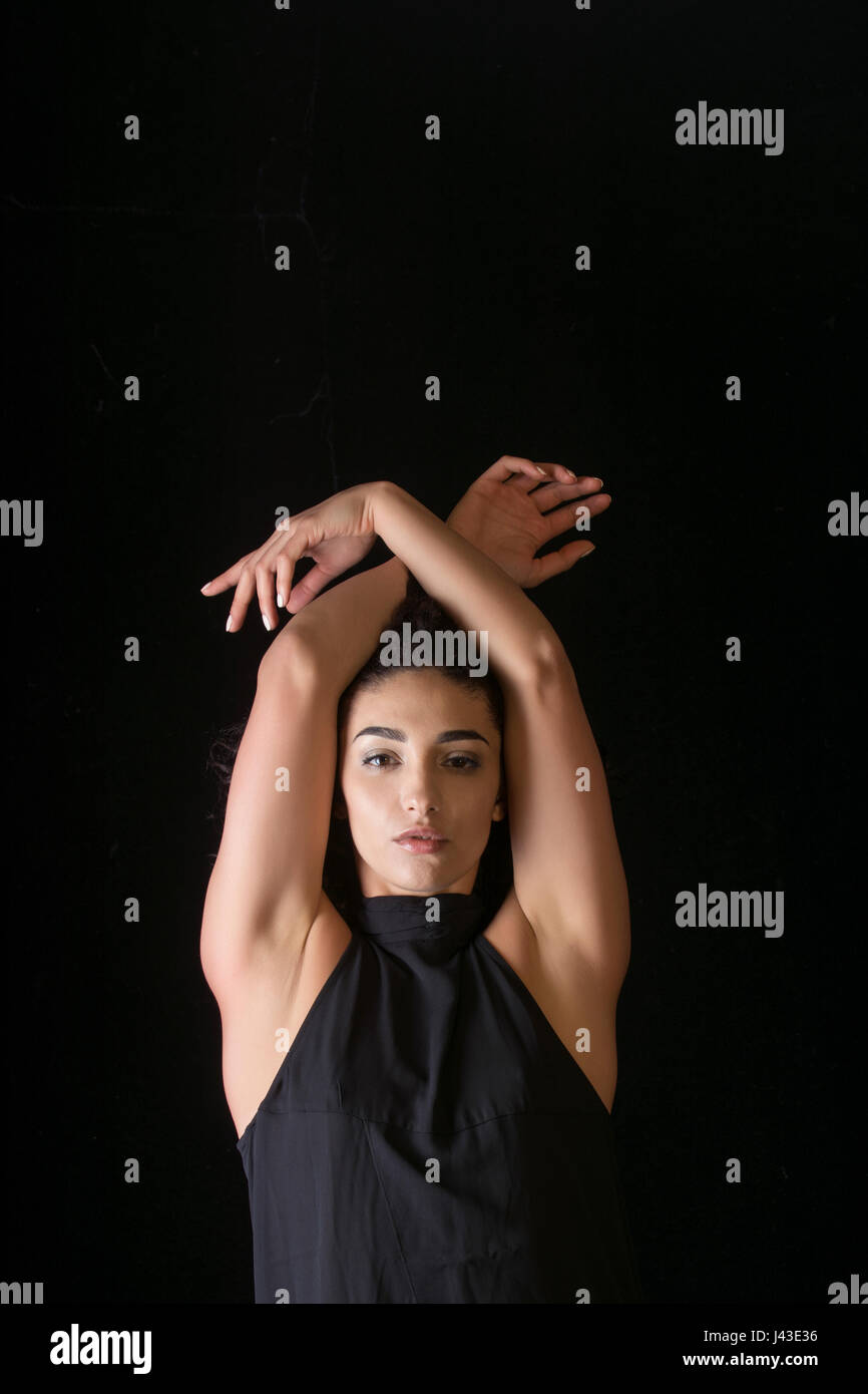 Beautiful young woman hands over head Stock Photo - Alamy