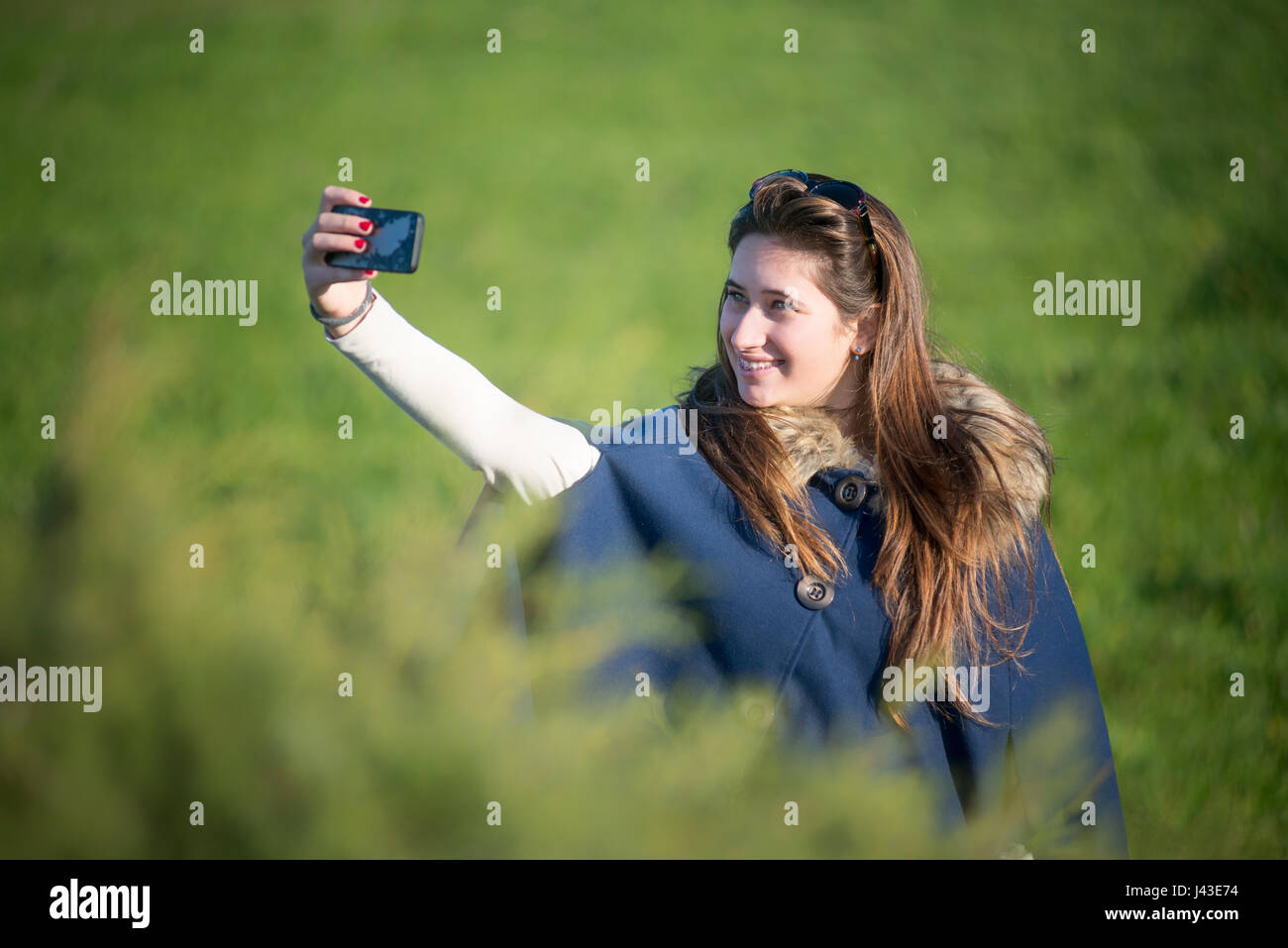 Beautiful and happy young girl posing outdoors Stock Photo - Alamy