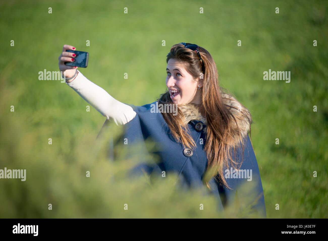 Beautiful and happy young girl posing outdoors Stock Photo - Alamy