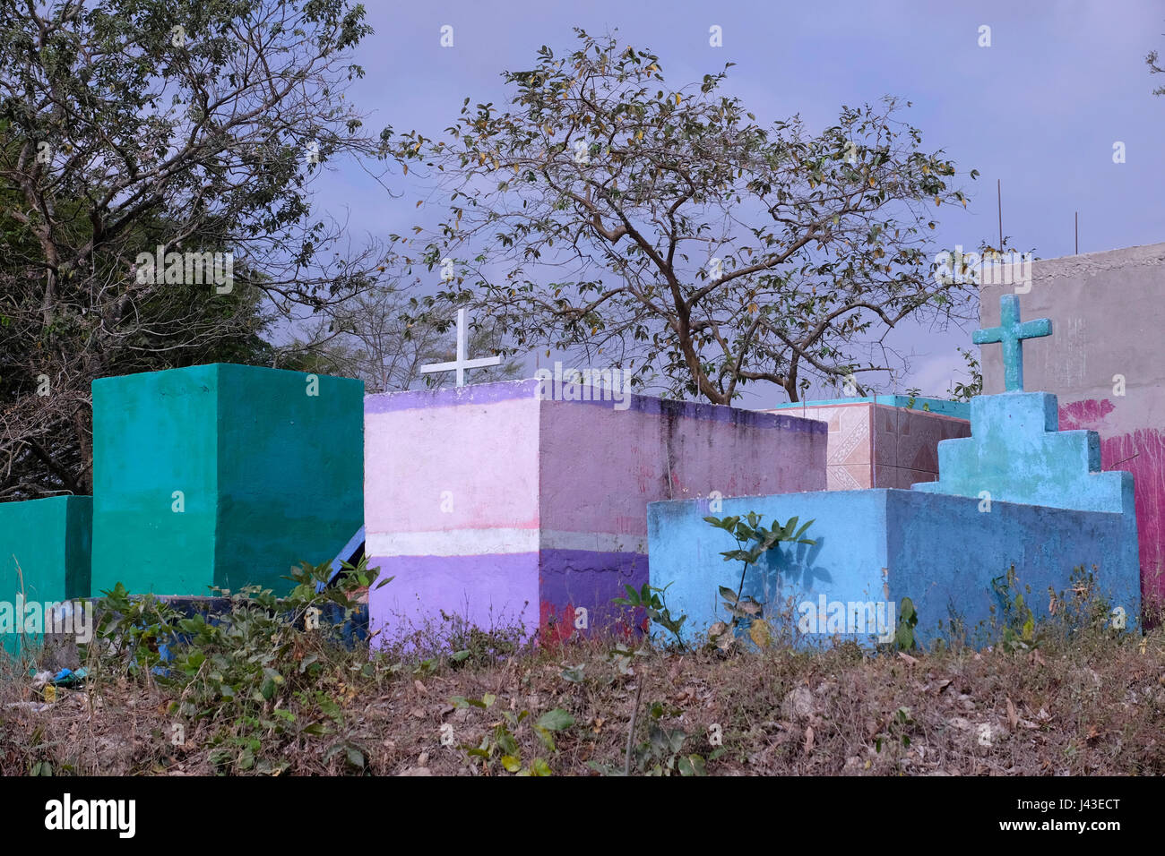 Brightly painted mausoleums and above ground crypts at a cemetery in ...