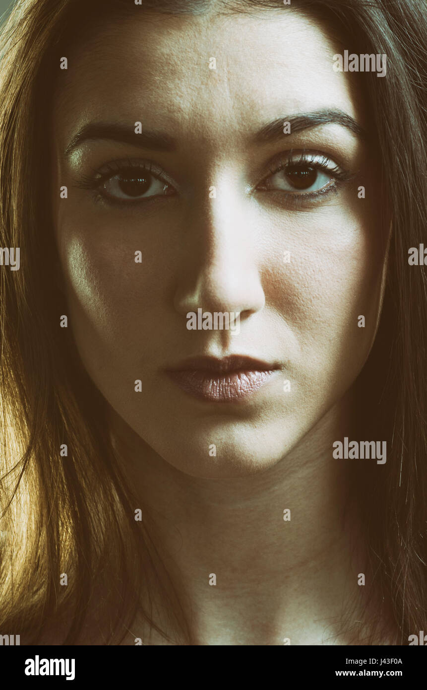 Portrait of a serious young woman staring Stock Photo - Alamy