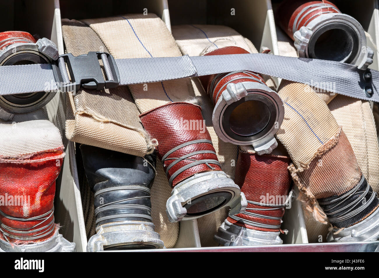 Rolled up fire hose hi-res stock photography and images - Alamy
