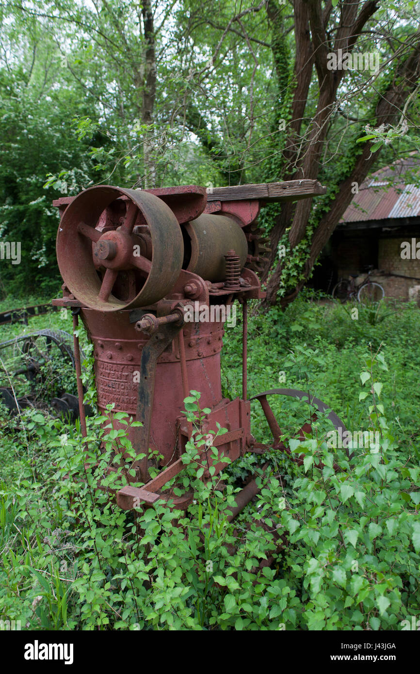 Abandoned and overgrown machine awaiting restoration Stock Photo - Alamy