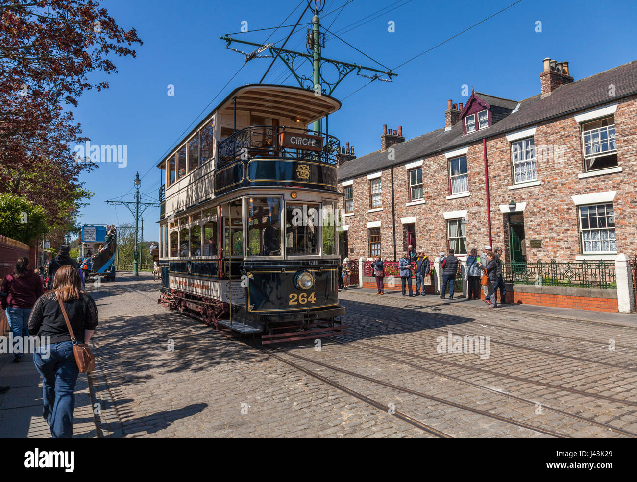 A tram makes it way down the old fashioned street at Beamish Museum ...