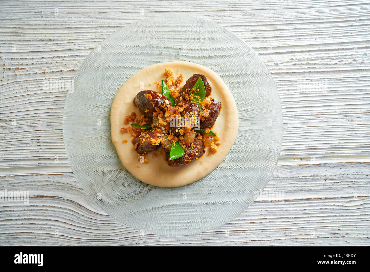 Iberia iberico pig cheeks pork meat with mangetout sugar snap peas ...