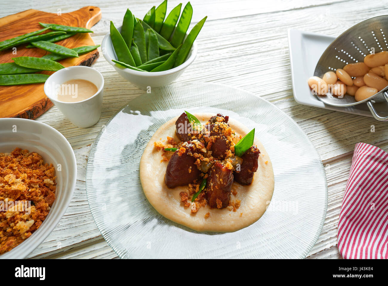 Iberia iberico pig cheeks pork meat with mangetout sugar snap peas ...