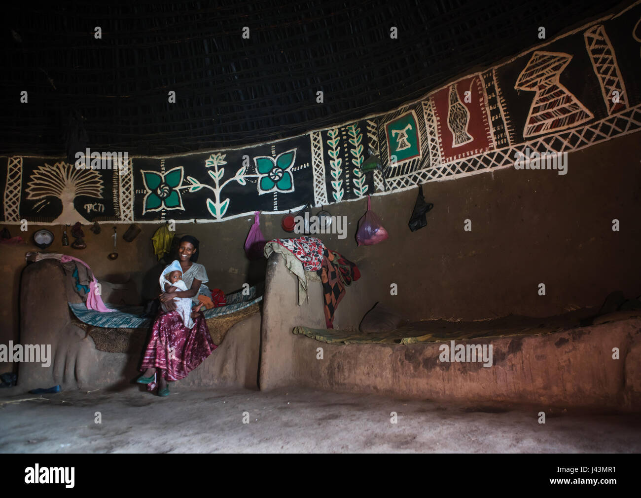 Ethiopian woman inside her traditional painted and decorated house ...